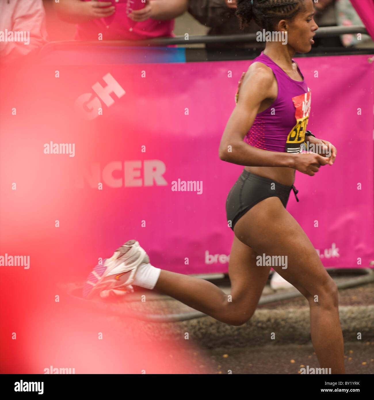 An elite woman runner races past the 25 mile marker in London Marathon ...