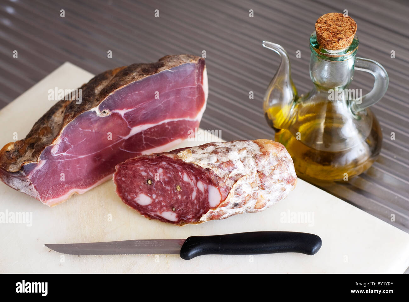 Prosciutto crudo, salami and olive oil Stock Photo - Alamy