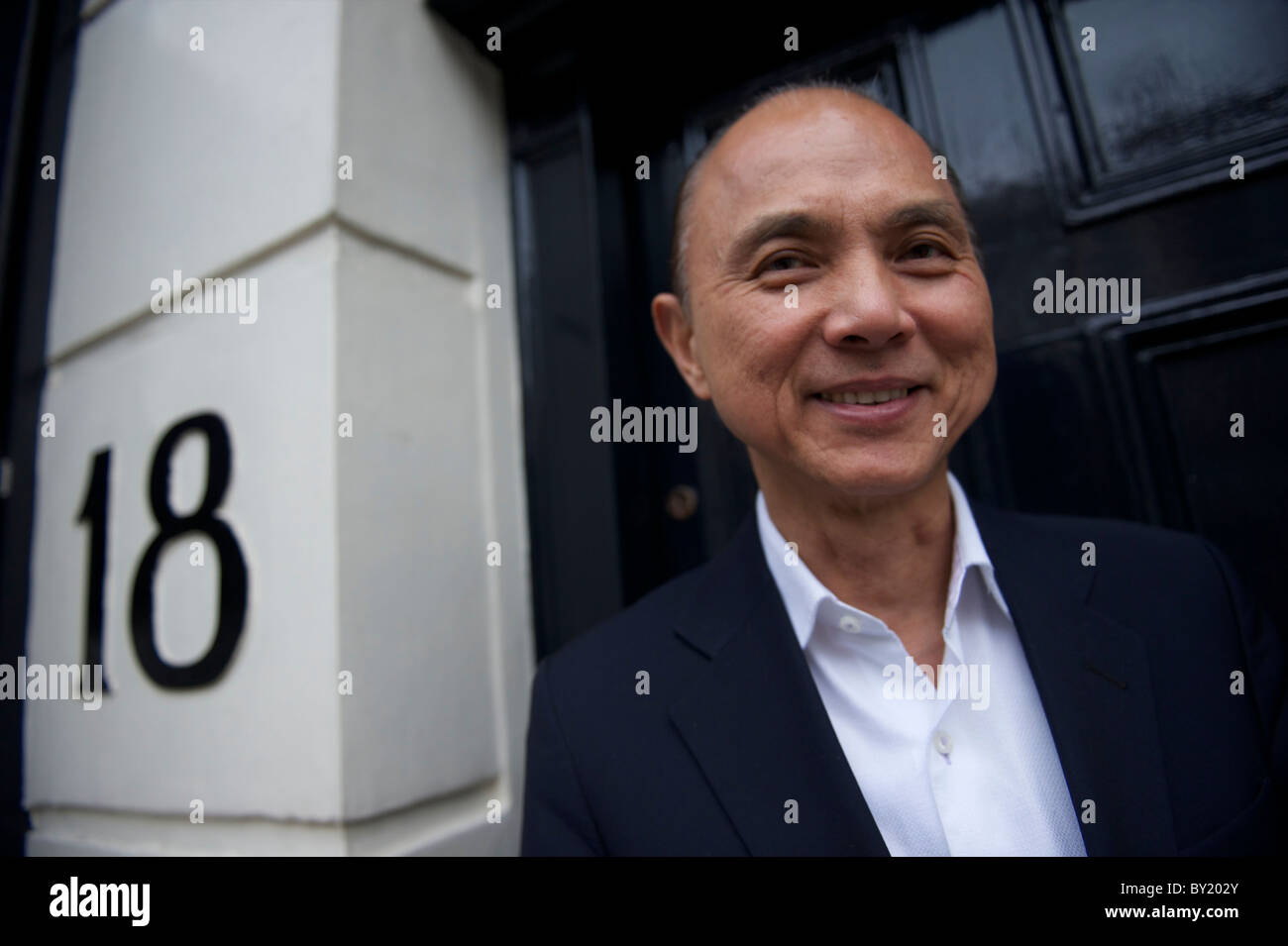 Fashion designer Jimmy Choo poses outside his store on Cannaught Street ...