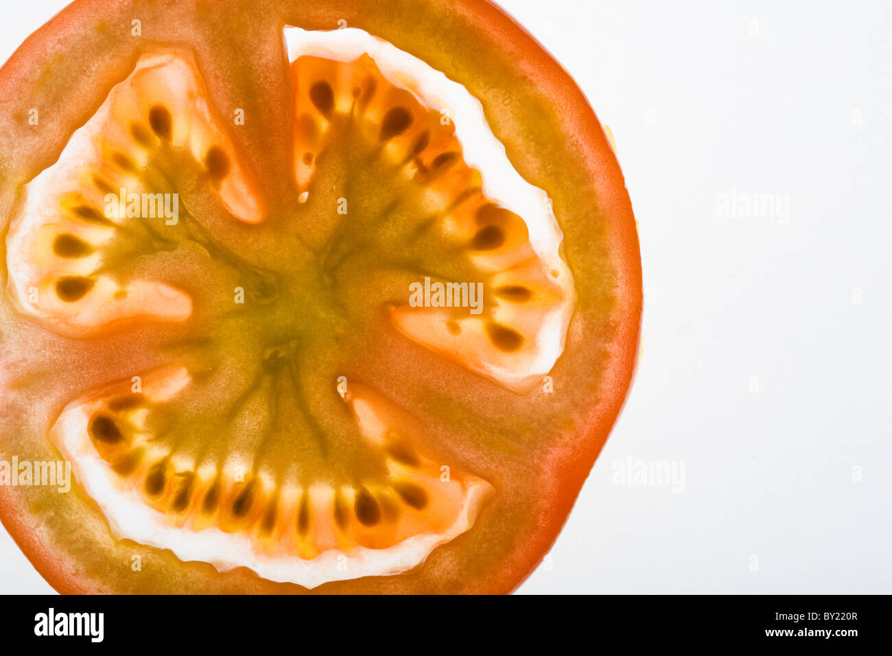 Close-up of tomato slice isolated over white background Stock Photo - Alamy