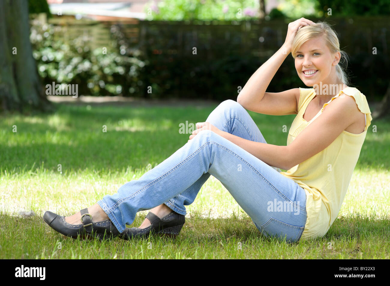 Young woman sitting in the park Stock Photo - Alamy