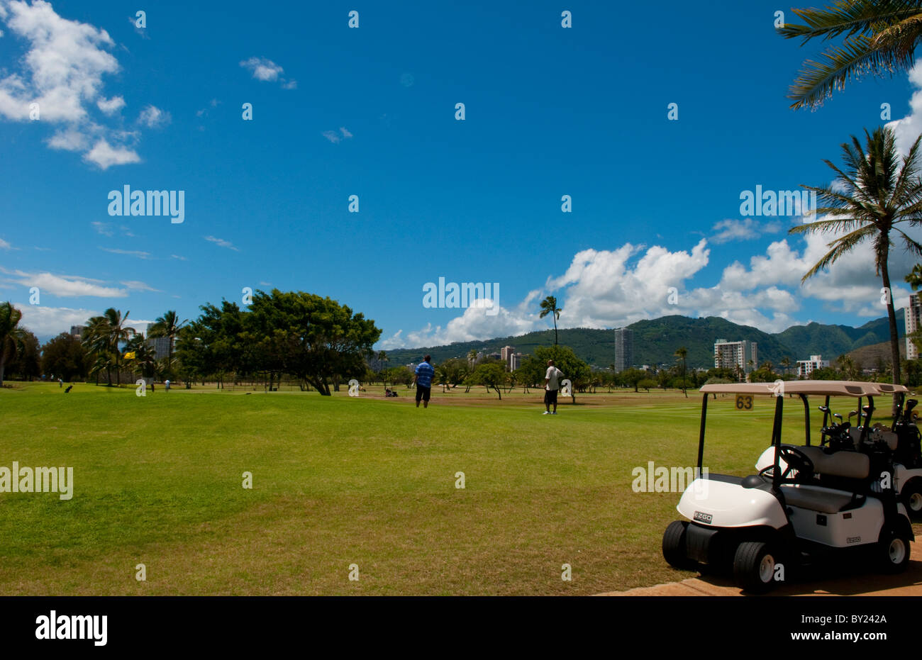 Honolulu Hawaii golfing at local Ala Wai Golf Course with Honolulu city ...