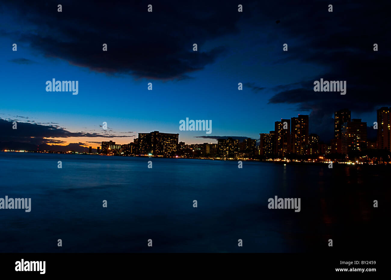 Hawaii Honolulu twilight of Waikiki Beach at night with colorful sky in ...