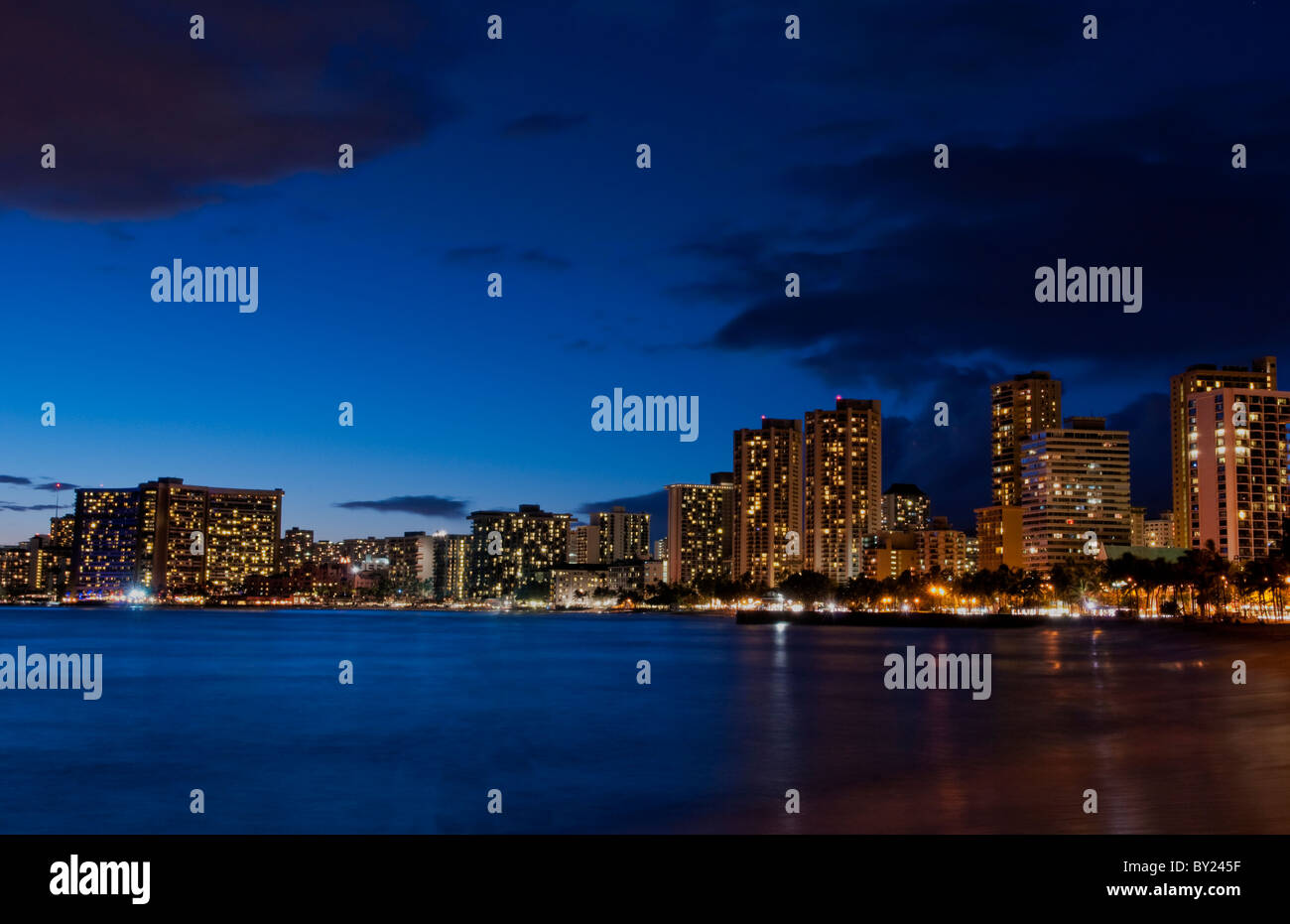 Hawaii Honolulu twilight of Waikiki Beach at night with colorful sky in ...