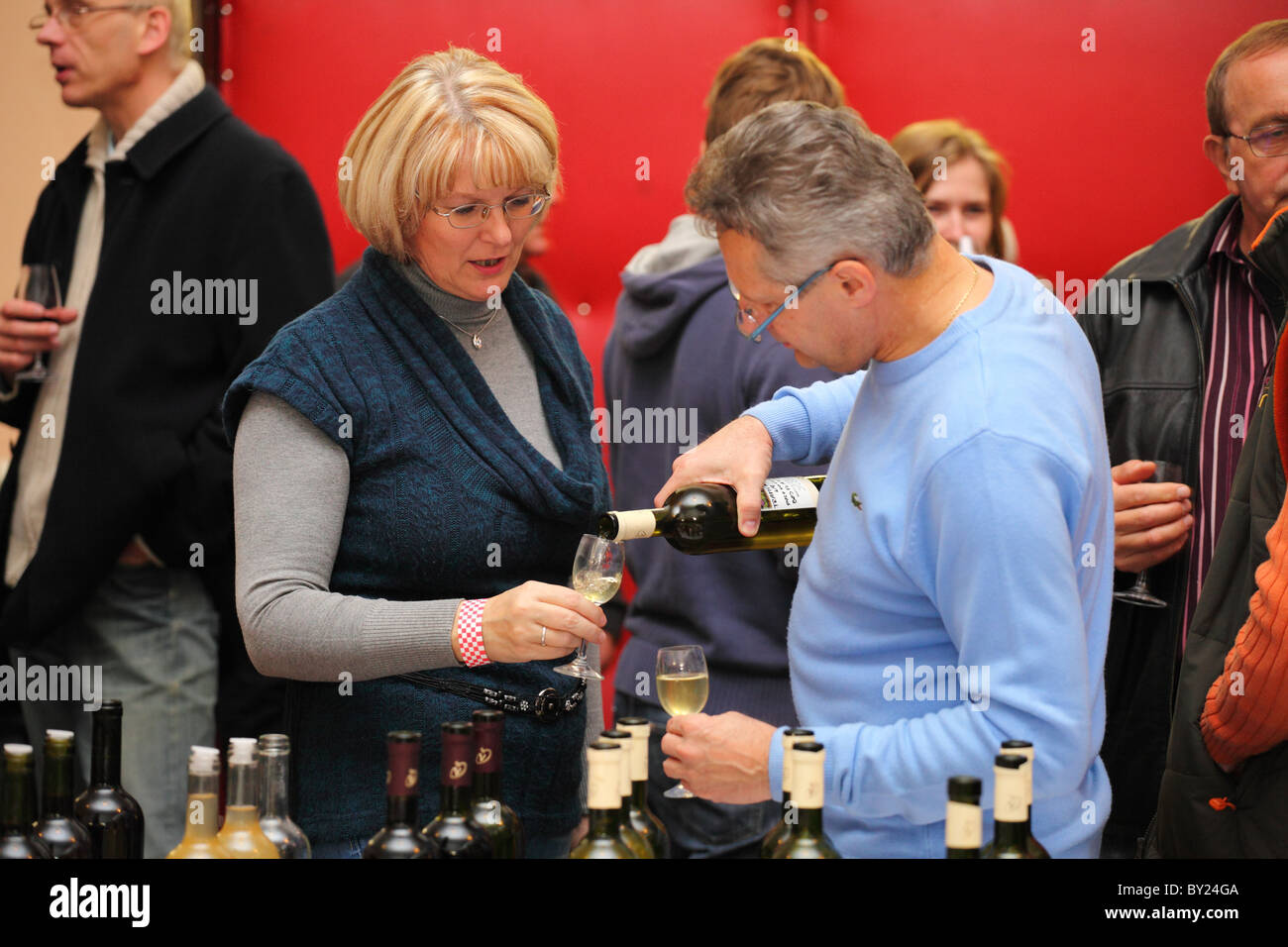 Man and woman with red wine tasting in wine cellar hi-res stock ...