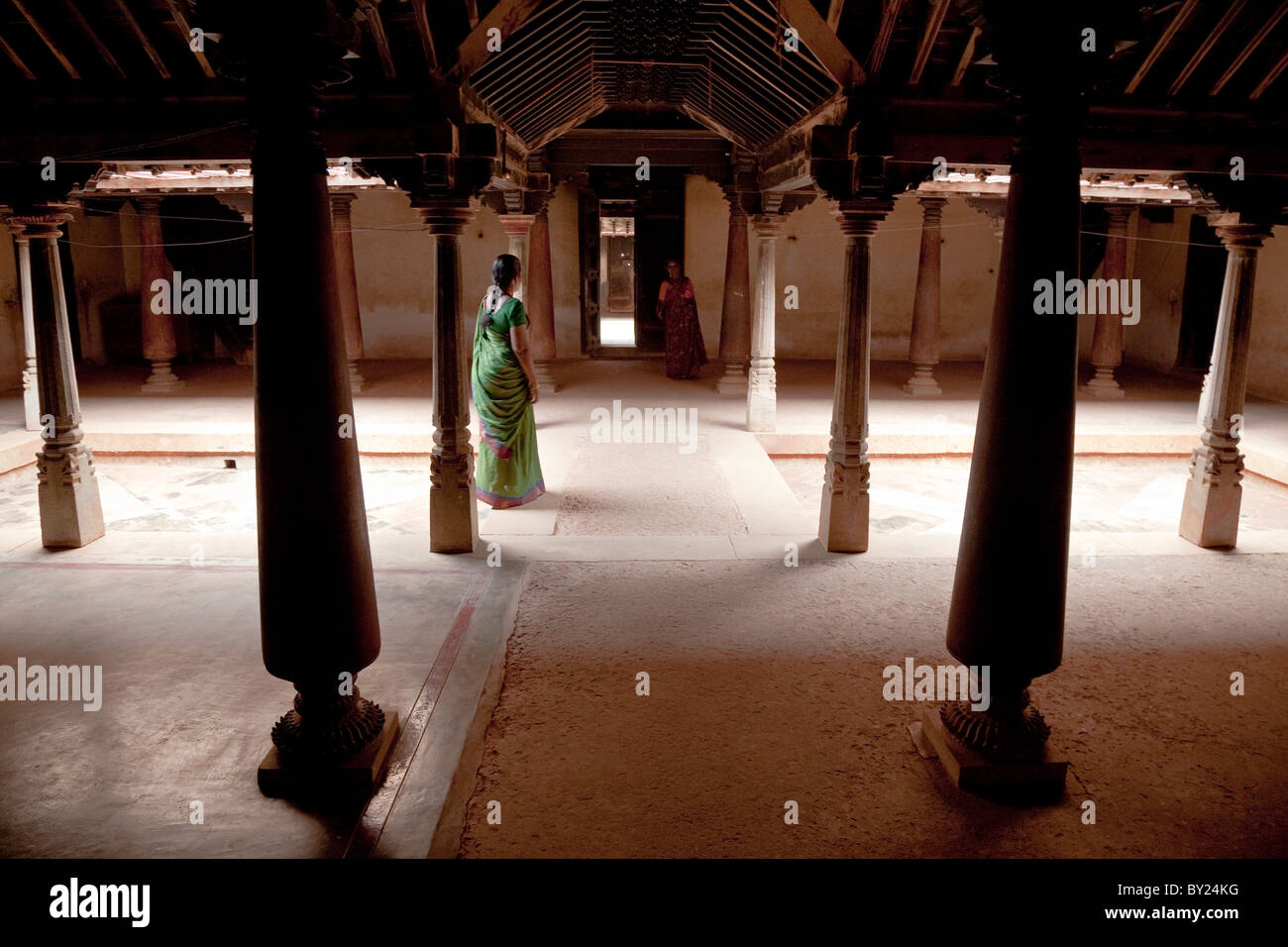 India, Chettinad. A Chettinad lady walks through an old mansion ...