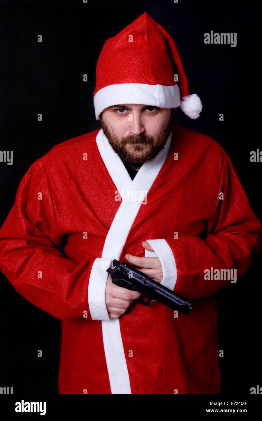 young man dressed as santa with a gun Stock Photo - Alamy