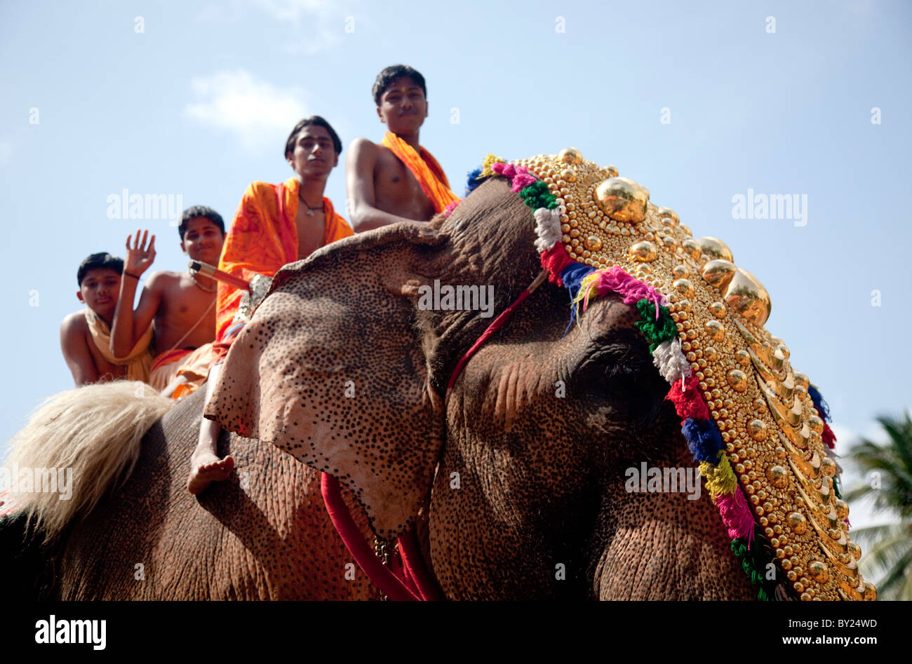 India, Palakkad. Young priests sit on an elborately-decorated holy ...