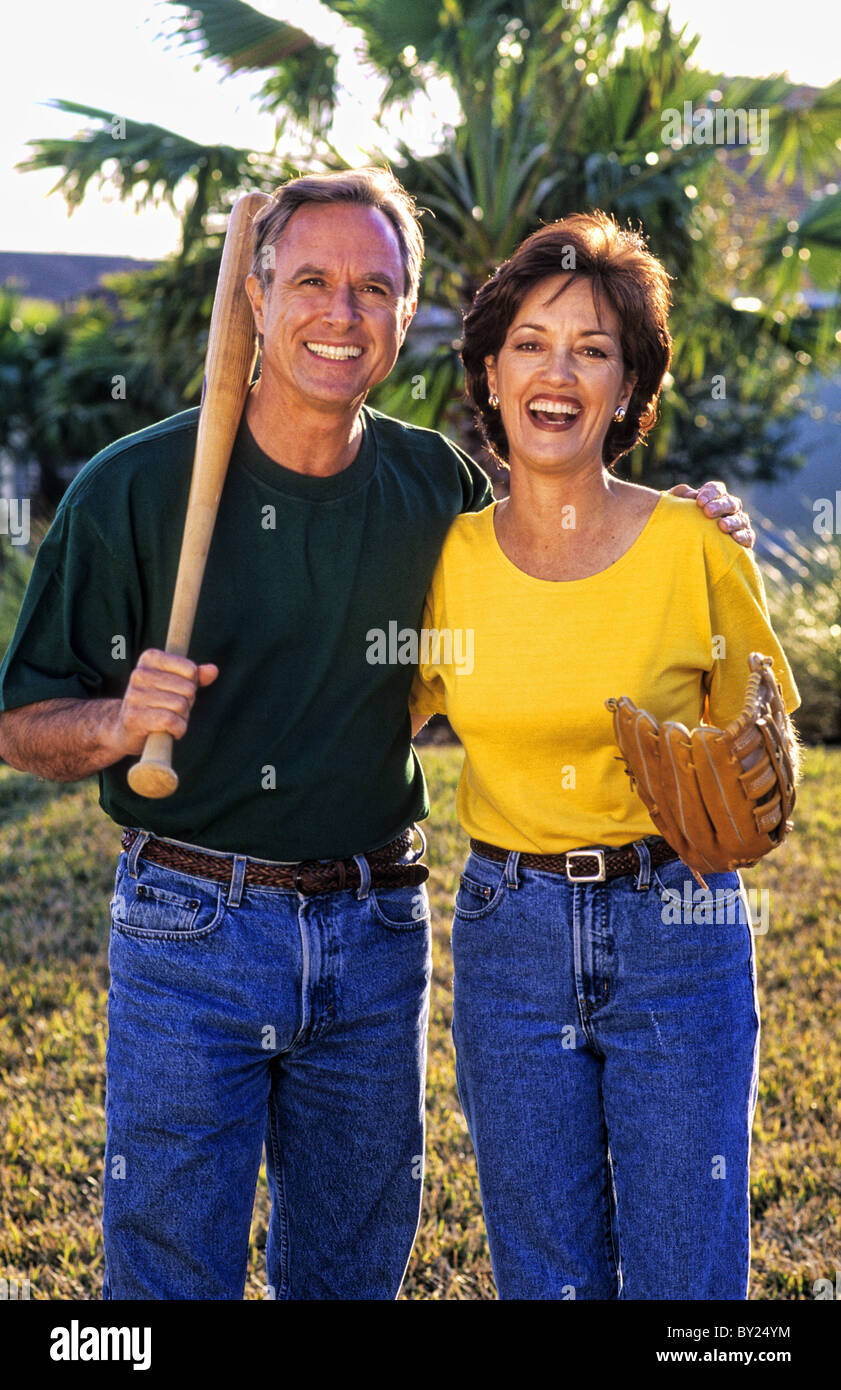 Retired couple in 50s with baseball and bat playing and laughing Stock ...