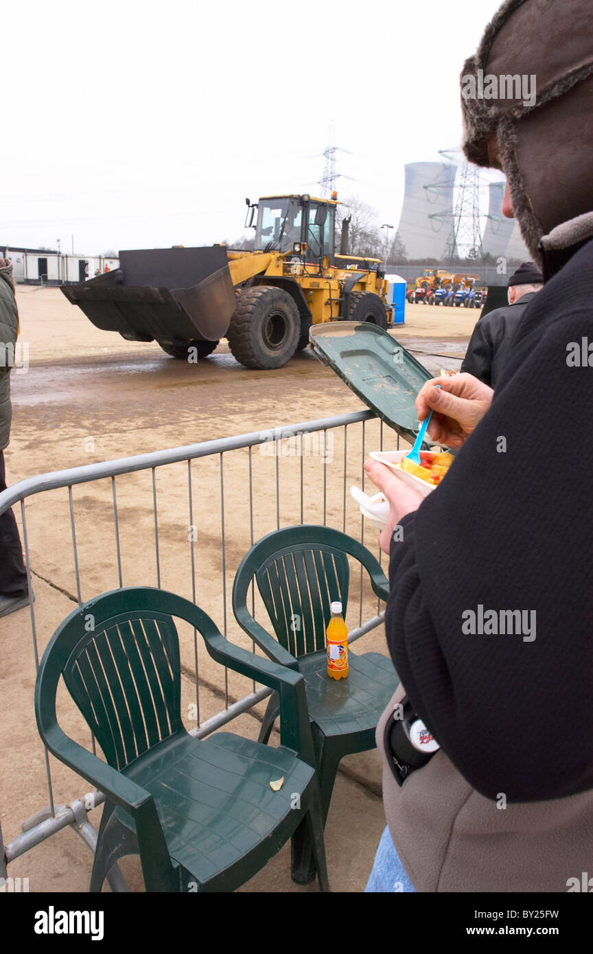 Man at auction with front loader on view Stock Photo - Alamy