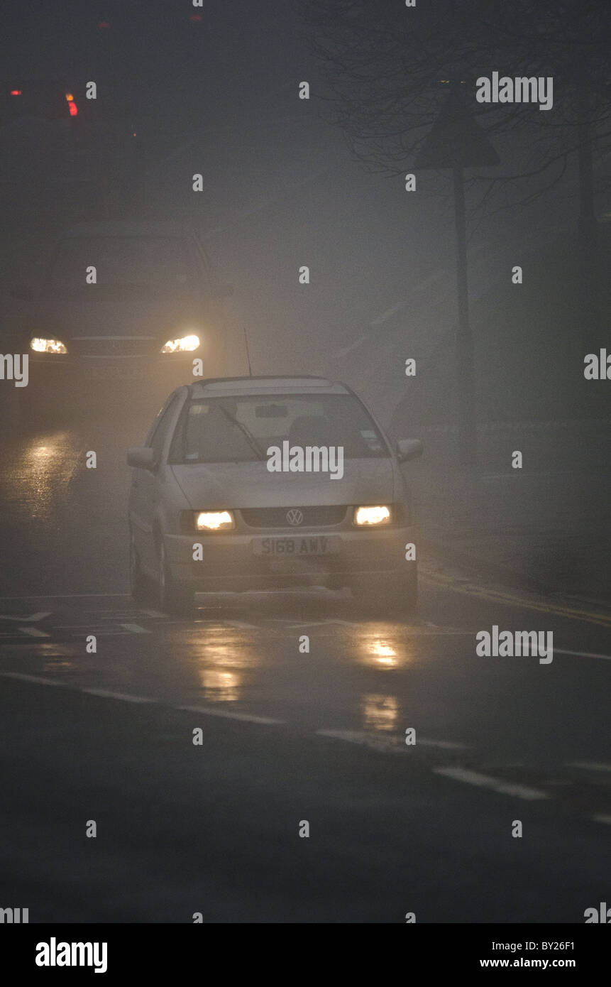 Cars driving in thick fog Stock Photo - Alamy
