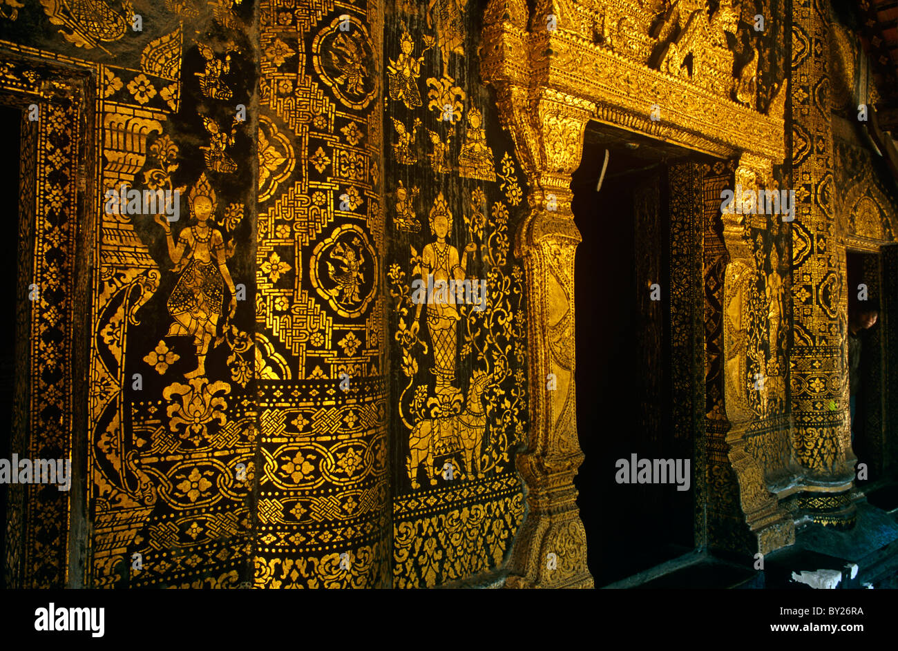 Laos, Luang Prabang Province, Luang Prabang. Gold-paint stencil murals ...