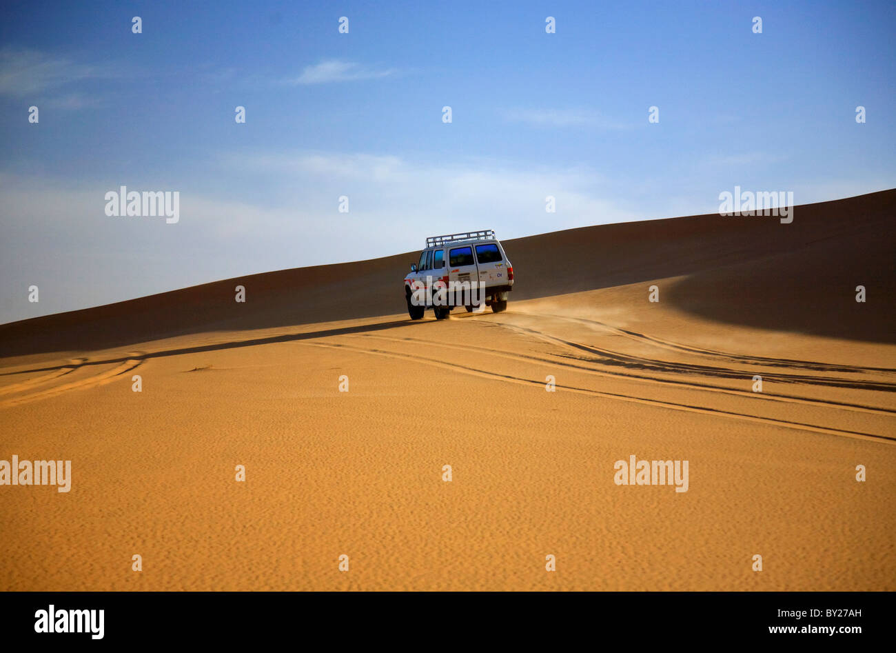 Ghadames, Libya; A 4x4 driven over desert dunes just outside the old ...