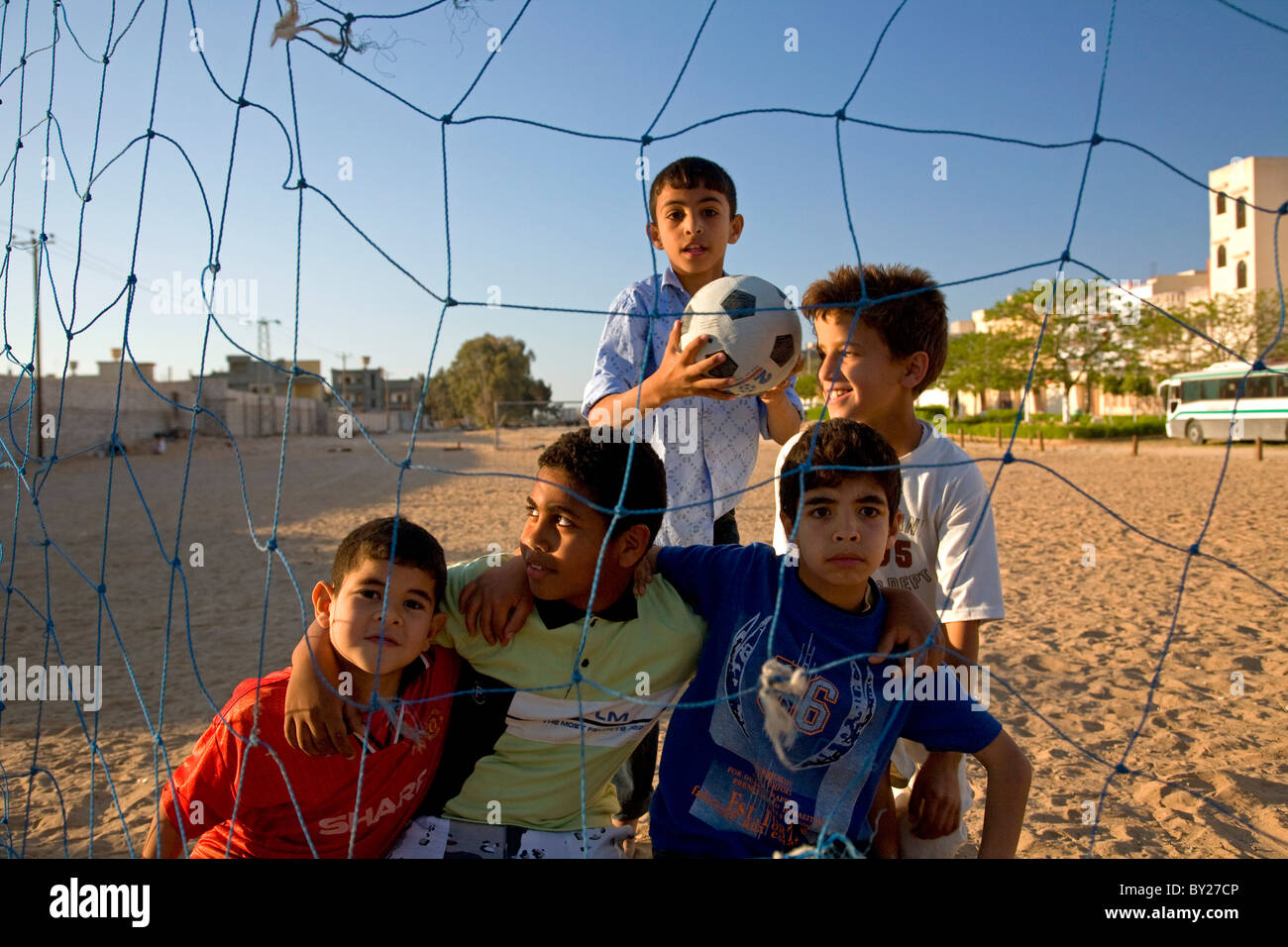 Tripoli, Libya; Children posing for a photograph after a football match ...