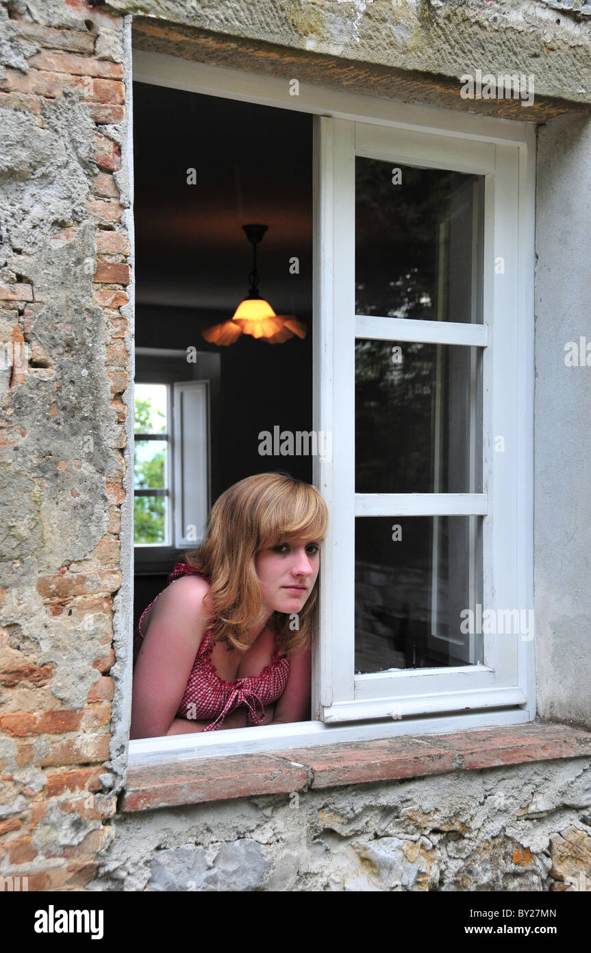 Girl in the window Stock Photo - Alamy