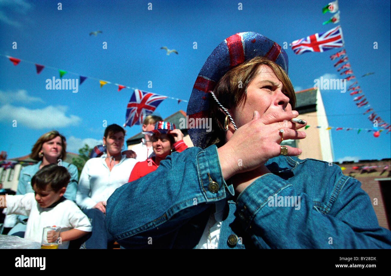 A lady smoking a cigarette at a party celebrating the Golden Jubilee ...