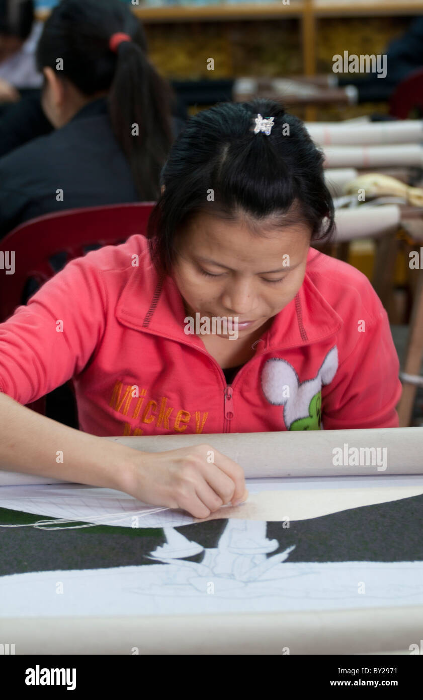 Woman sewing factory labor work making tedious handmade items in Hanoi ...