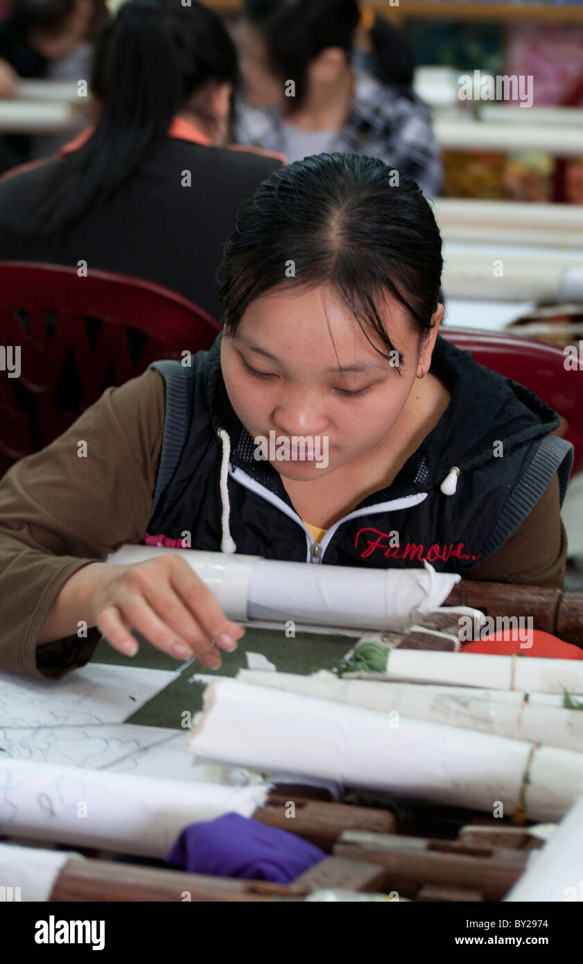 Woman sewing factory labor work making tedious handmade items in Hanoi ...