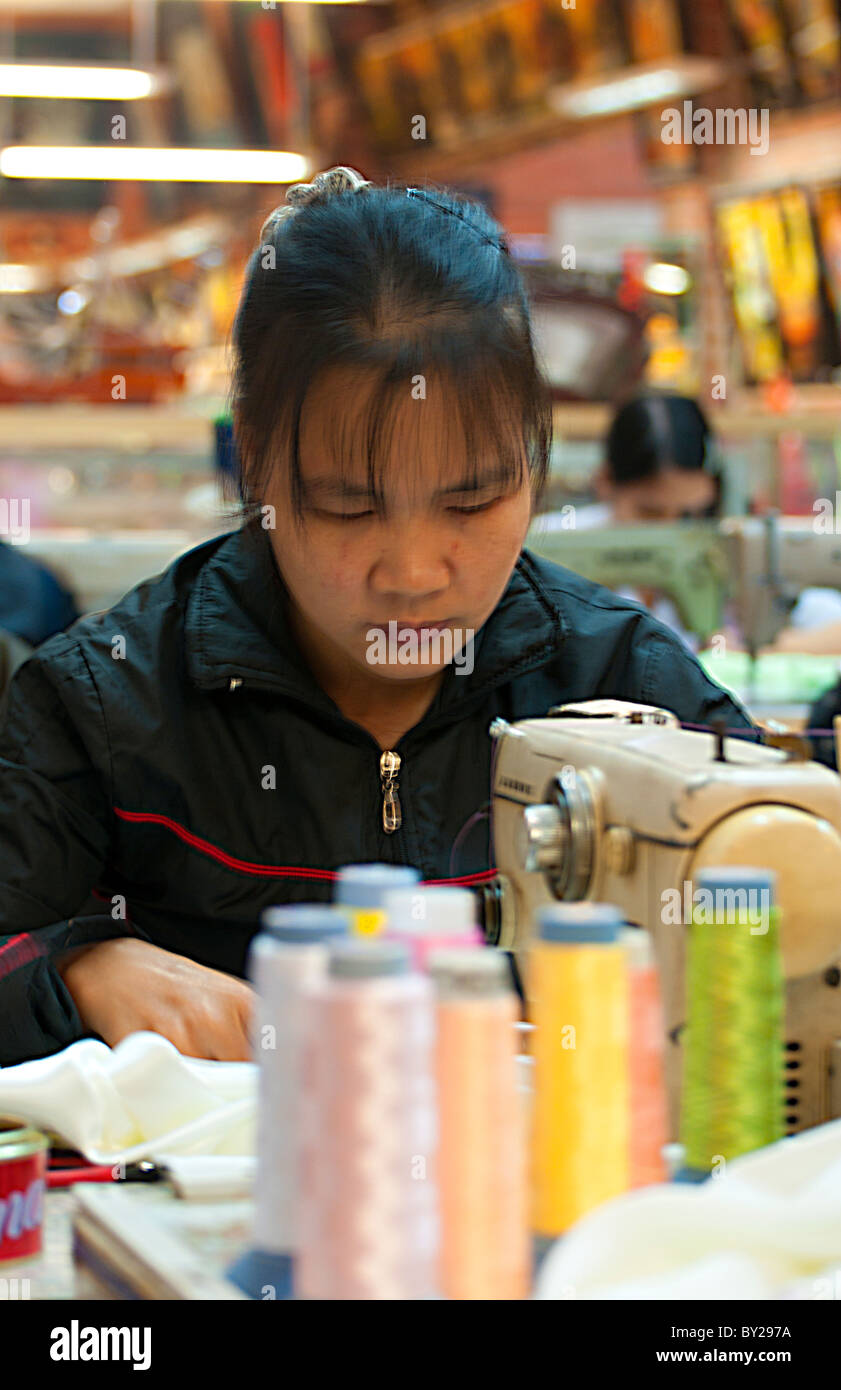 Woman sewing factory labor work making tedious handmade items in Hanoi ...