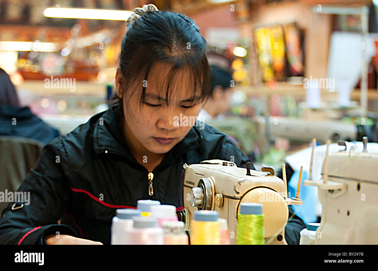 Woman sewing factory labor work making tedious handmade items in Hanoi ...