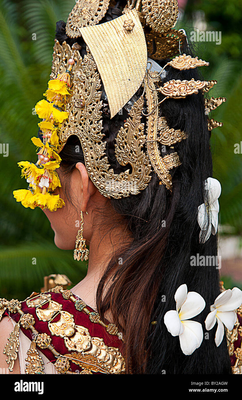 Dancer in native traditional gold ancient dance costume showing back of ...