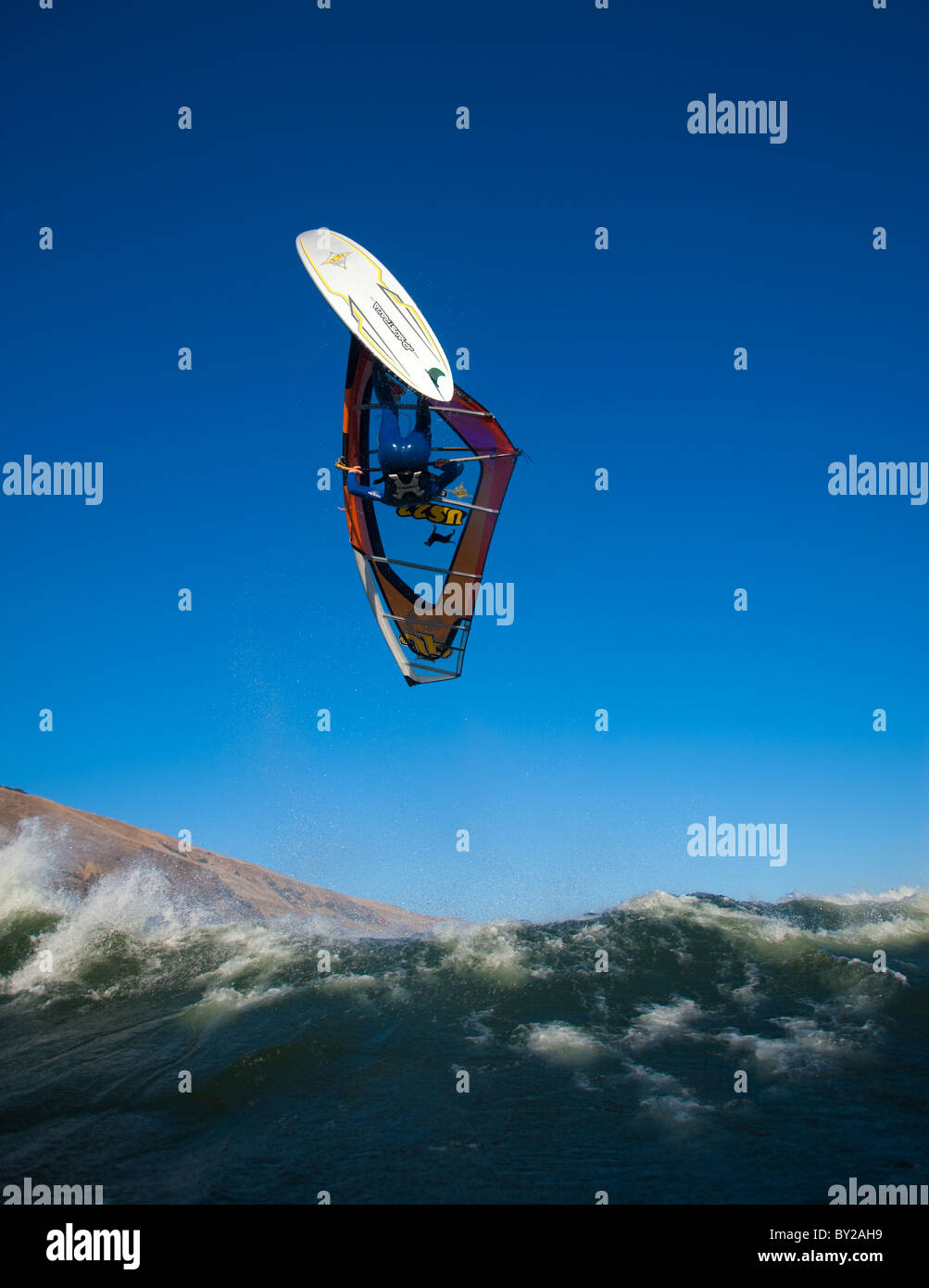 Windsurfer in mid Back Loop during a summer session at Dougs Beach ...