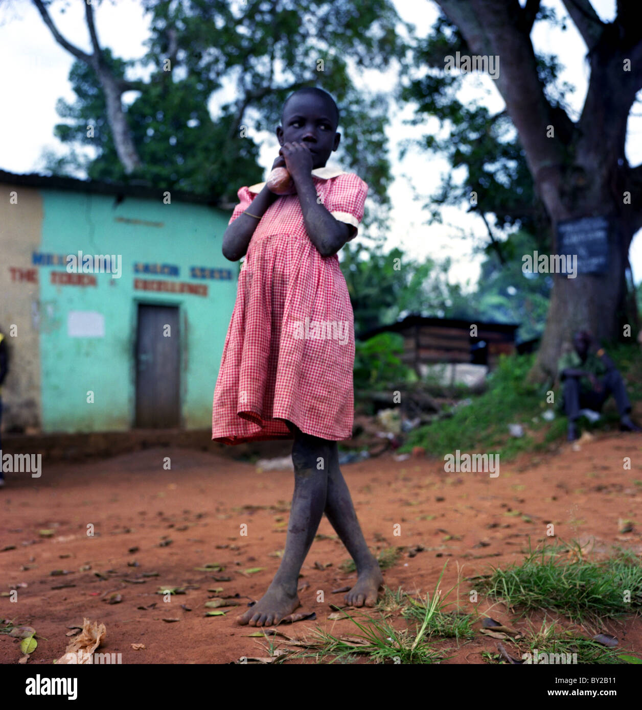 A girl with her legs crossed in Uganda. Africa Stock Photo - Alamy