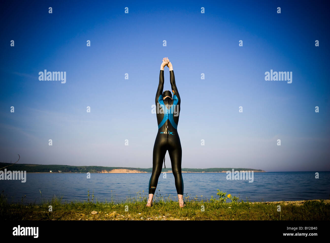 Swimmer stretches before swim. Wide angle Stock Photo - Alamy