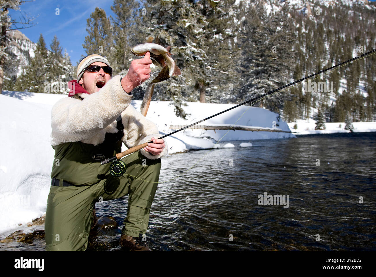 A man out fly fishing on a winter day Stock Photo - Alamy
