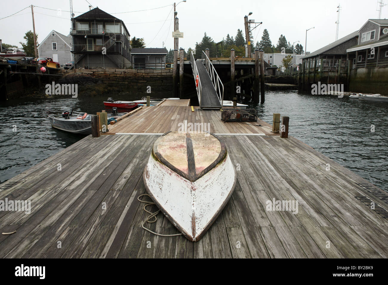 A row boat sits over turned on a dock to dry out in Acadia, Maine Stock ...