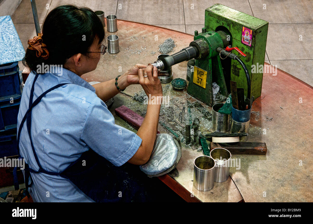 Worker finishing product design in Pewter Factory called Royal Selangor ...