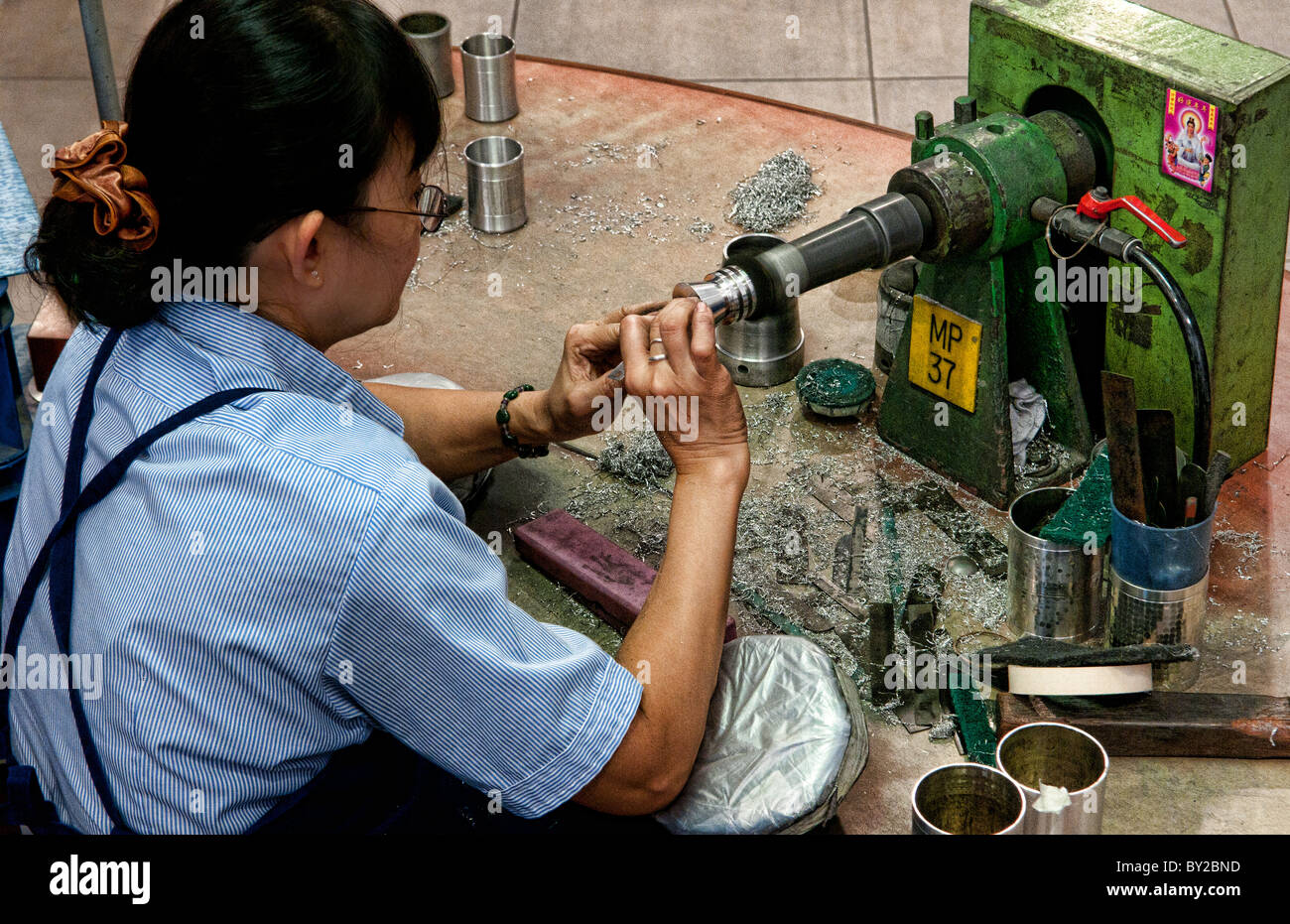 Worker finishing product design in Pewter Factory called Royal Selangor ...