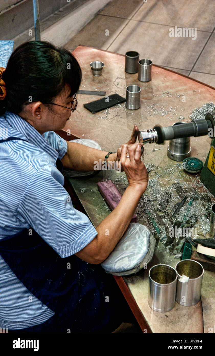 Worker finishing product design in Pewter Factory called Royal Selangor ...