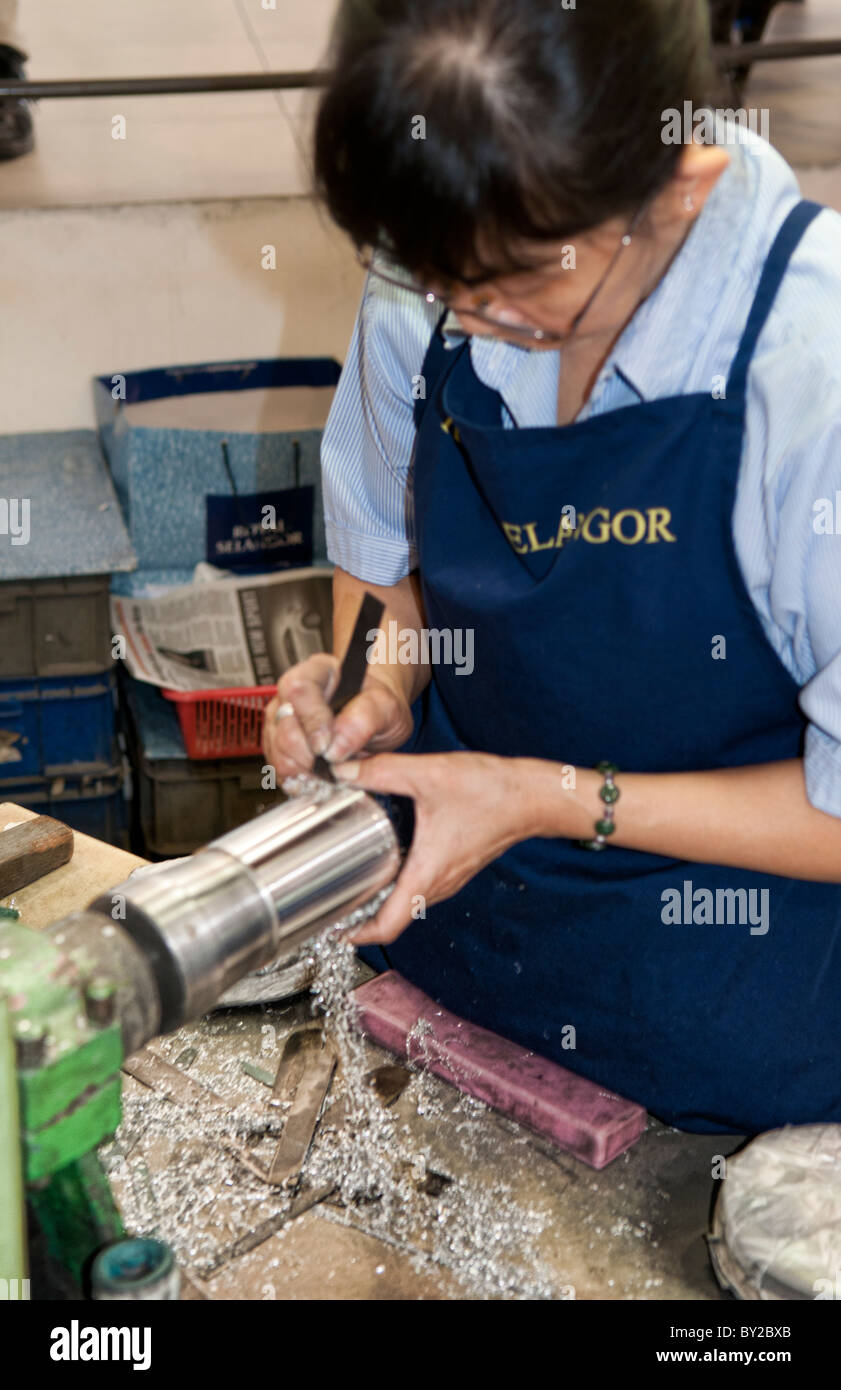 Worker finishing design in Pewter Factory called Royal Selangor in ...