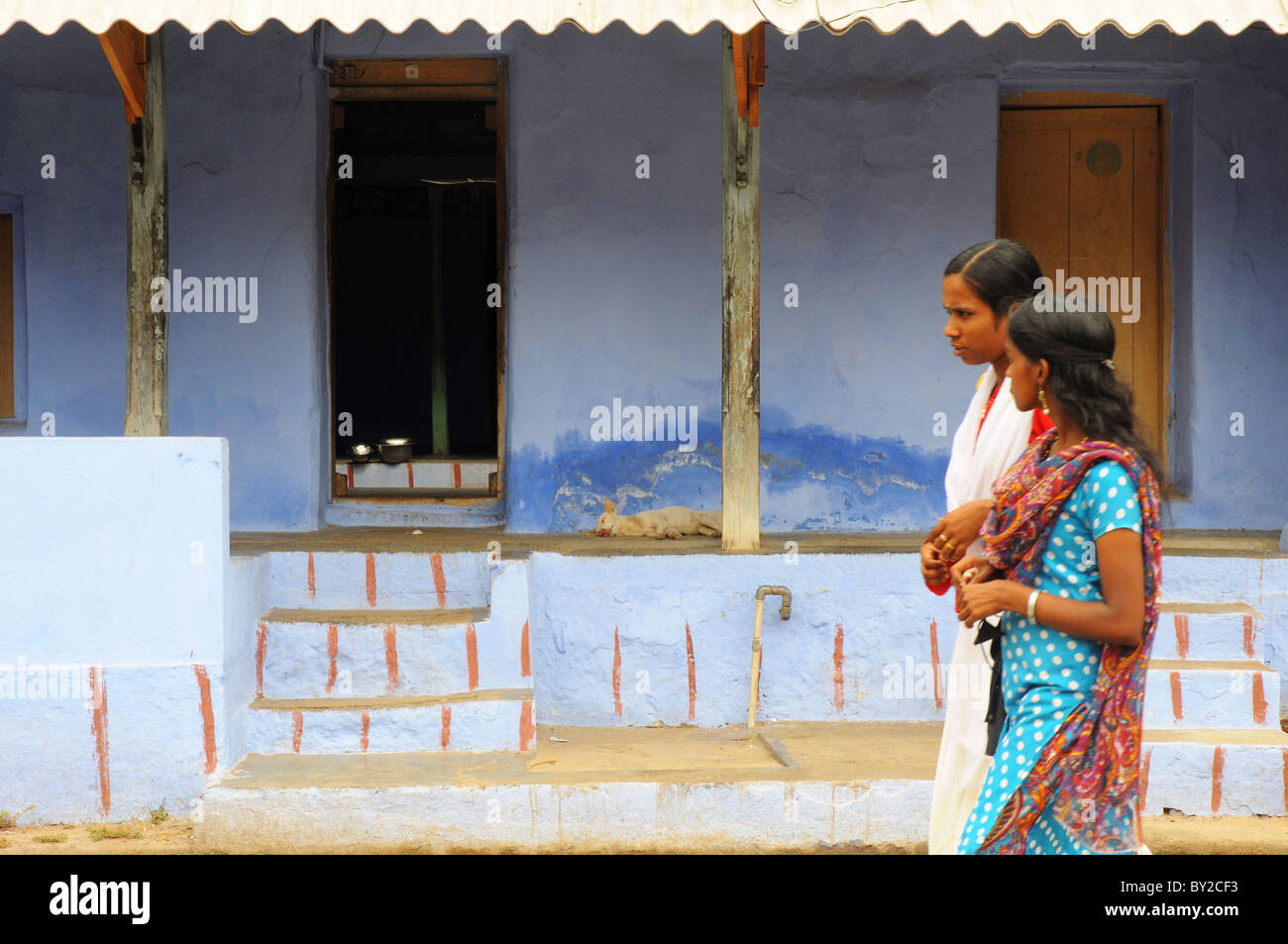 Two women passing by in an Indian street Stock Photo - Alamy