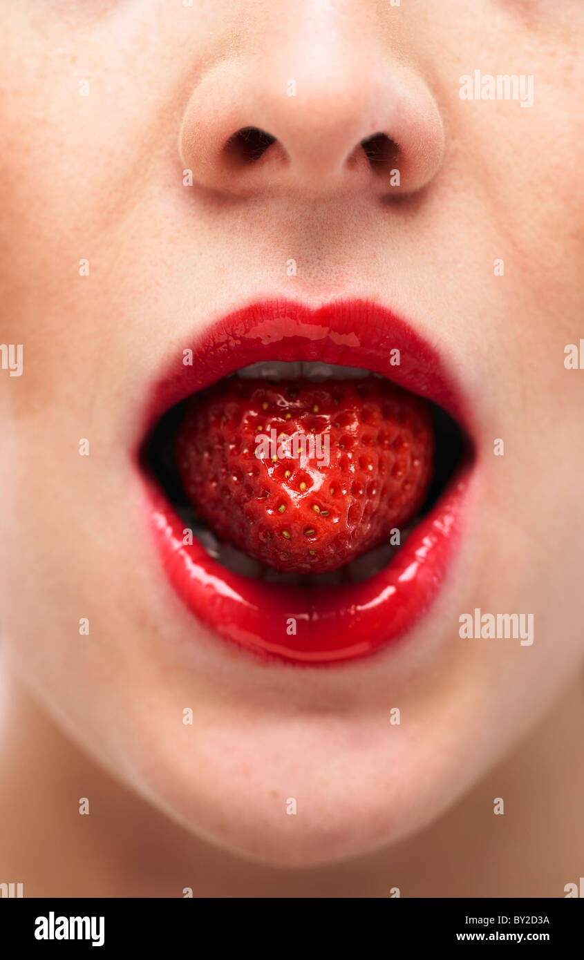 white woman biting on a stawberry Stock Photo - Alamy