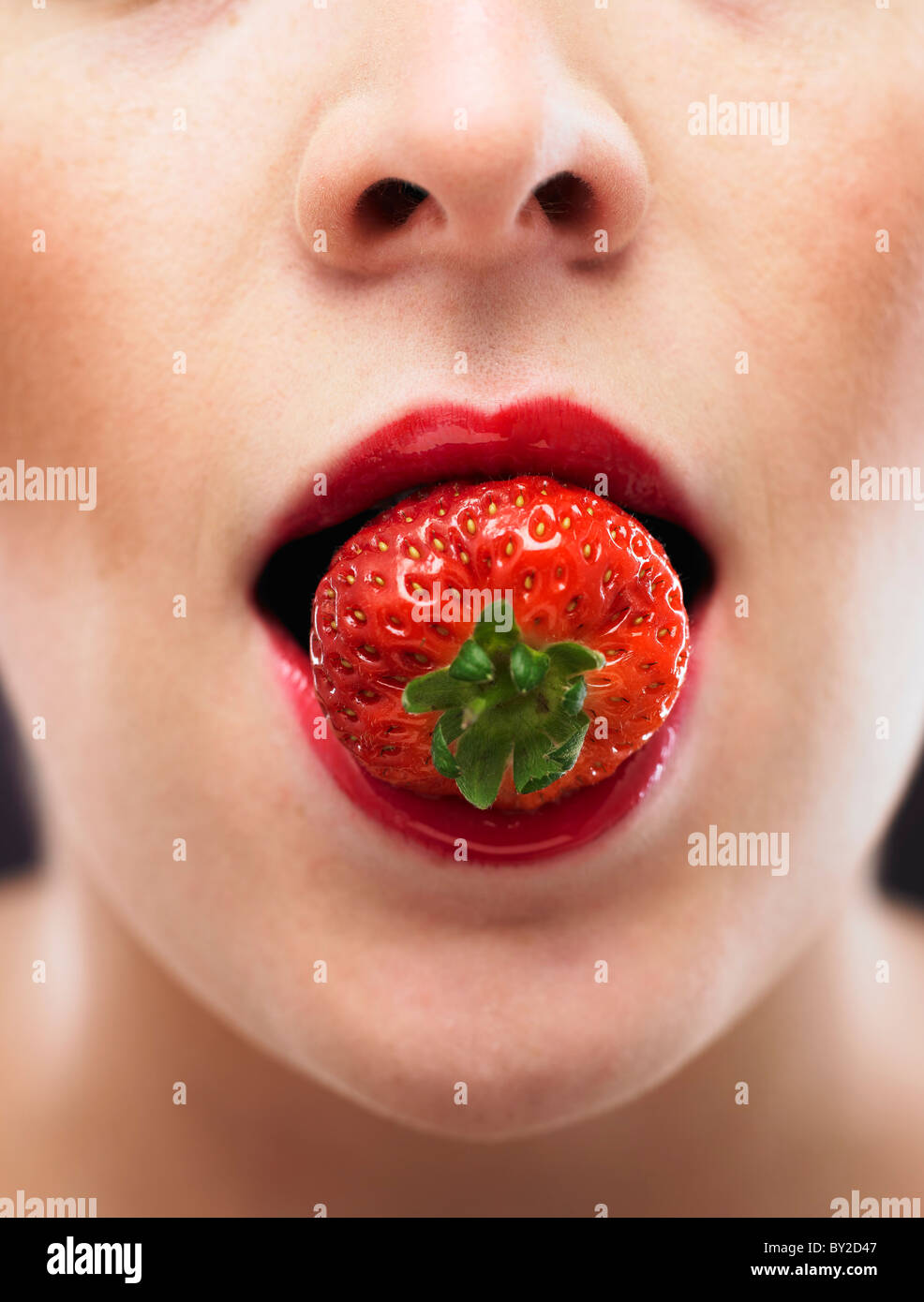 white woman biting on a stawberry Stock Photo - Alamy