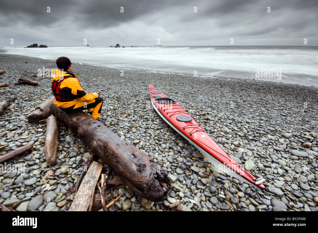 Young male sea kayaker, Ruby Beach, Olympic National Park, Washington ...
