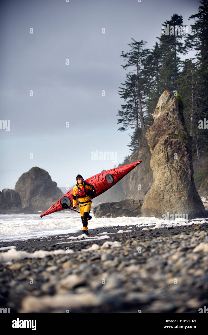 Young male sea kayaker, Ruby Beach, Olympic National Park, Washington ...