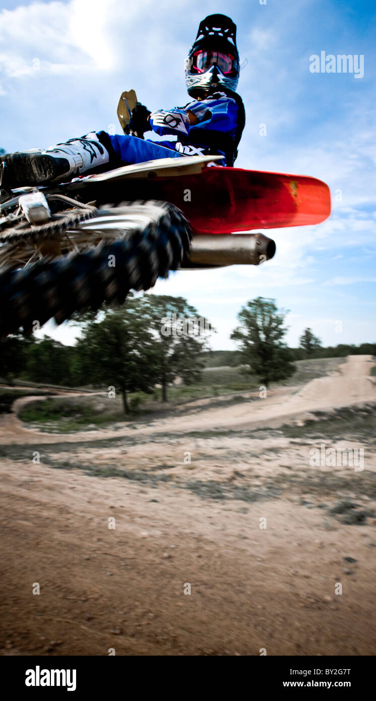 A motocross biker looks back in mid-air during a jump in Brainerd ...