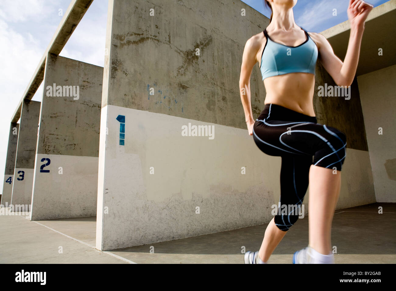 A woman running by a handball court Stock Photo - Alamy