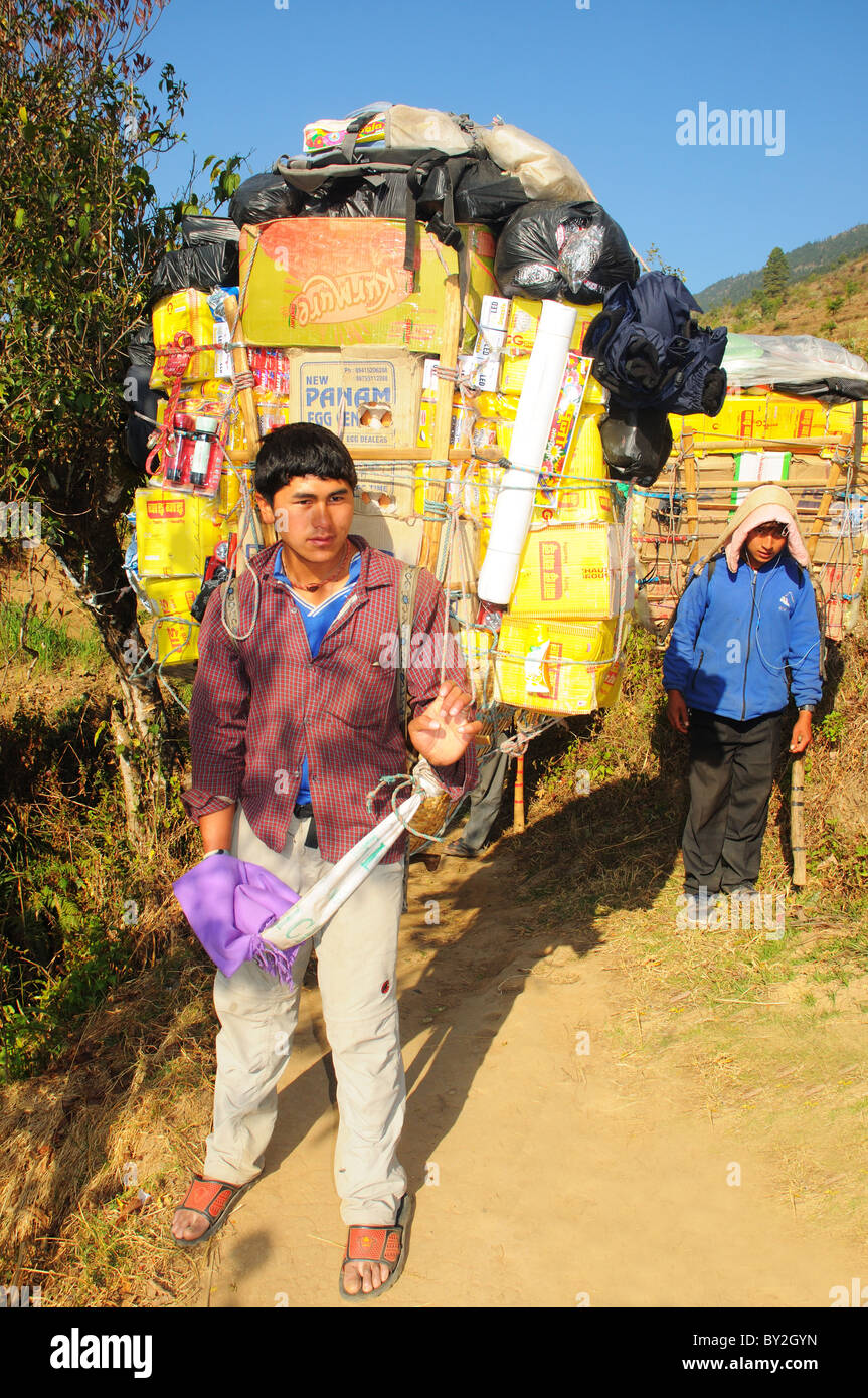 Heavily laden porters in Nepal Stock Photo - Alamy