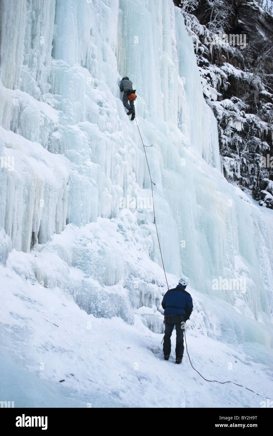 An ice climber climbing a blue ice fall at Korouoma, Posio in Lapland ...