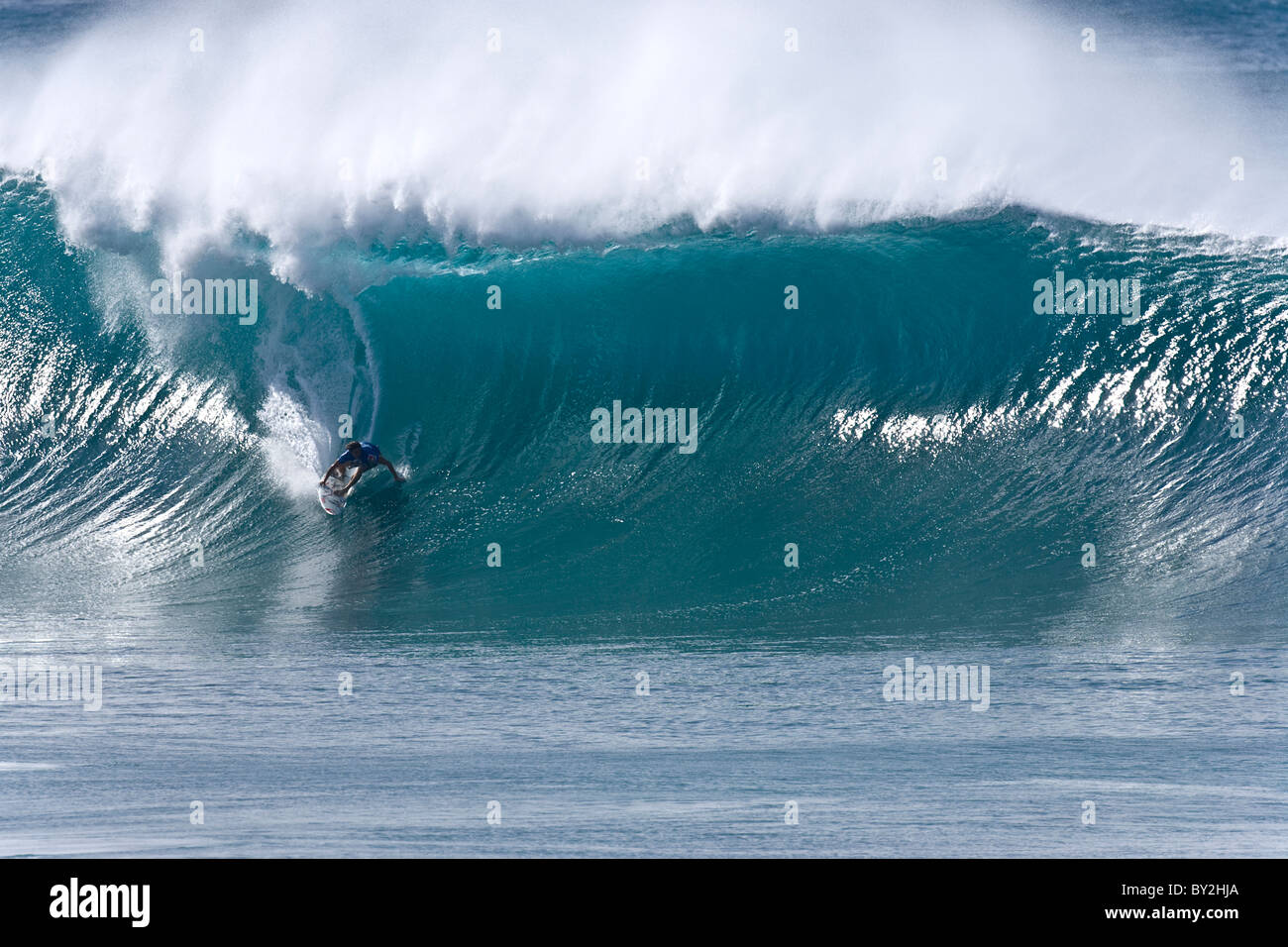 A young man surfs a perfect big barreling wave at the Pipeline, on th ...