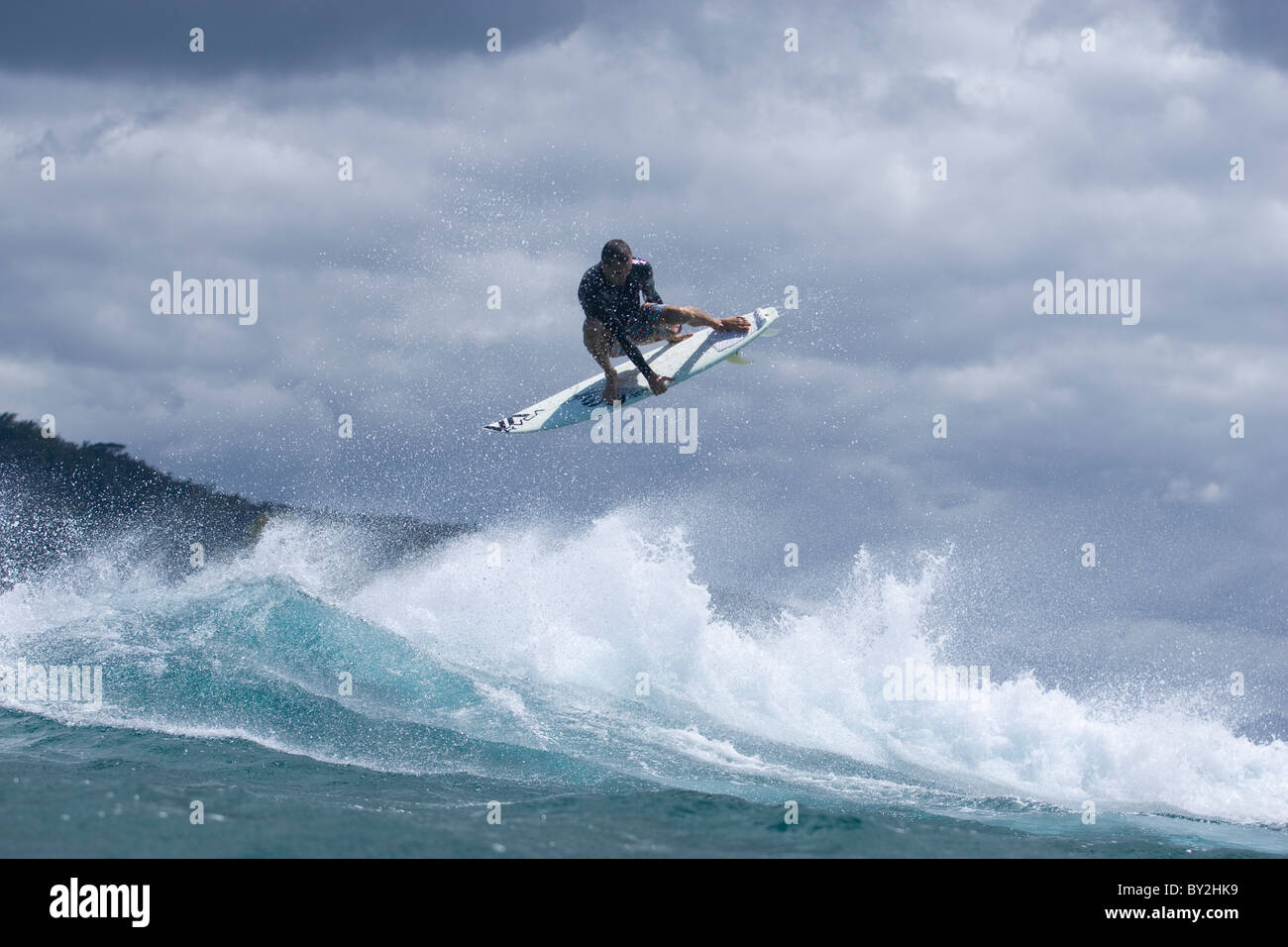 A young man surfing at Monster Mush on the north shore of Oahu, Hawaii ...