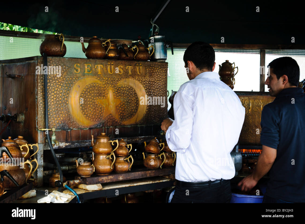 ISTANBUL, Turkey / Türkiye — Baristas make traditional Turkish tea at a ...
