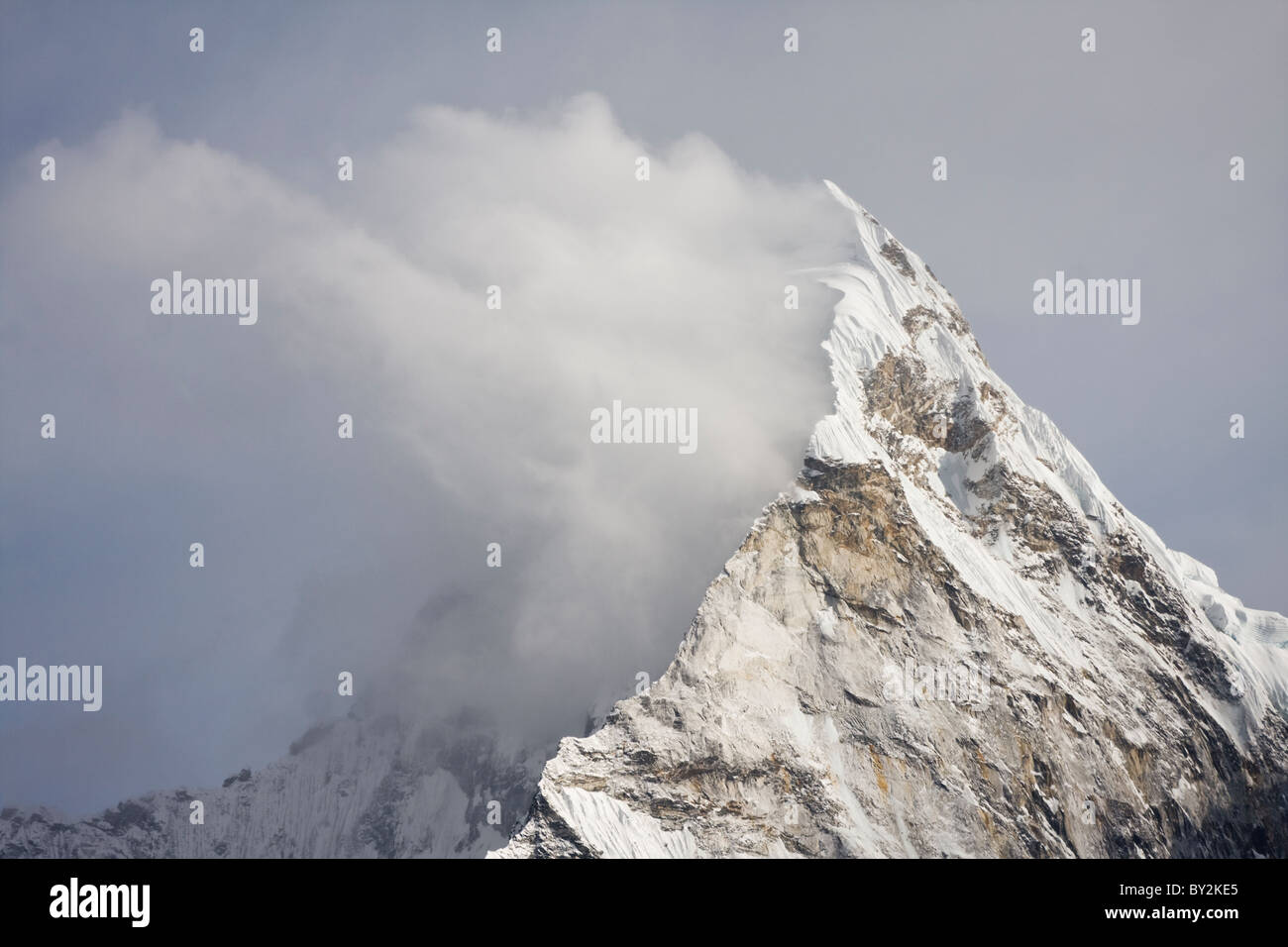 A plume of spindrift snow curls off the summit of Ama Dablam, Khumbu ...