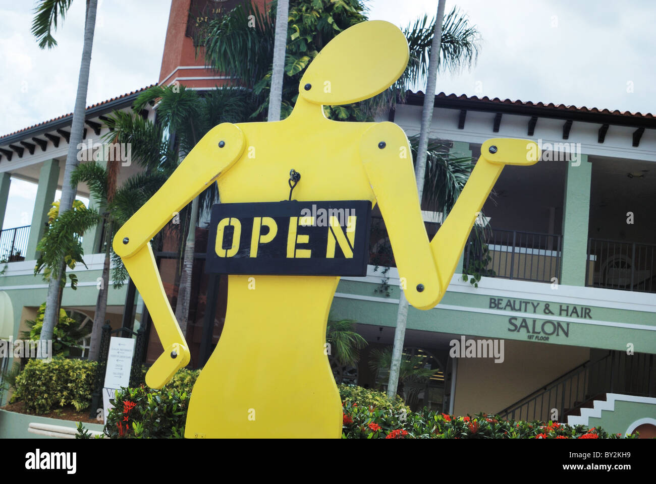 Unique "Open" sign in form of female shape in shopping mall in Naples ...
