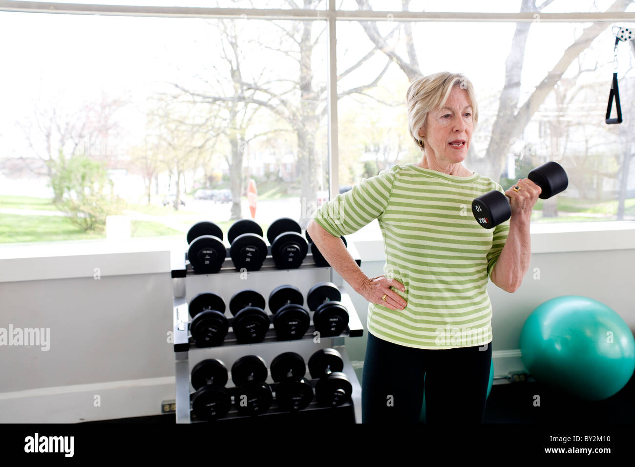 Older woman exercising in a gym Stock Photo - Alamy