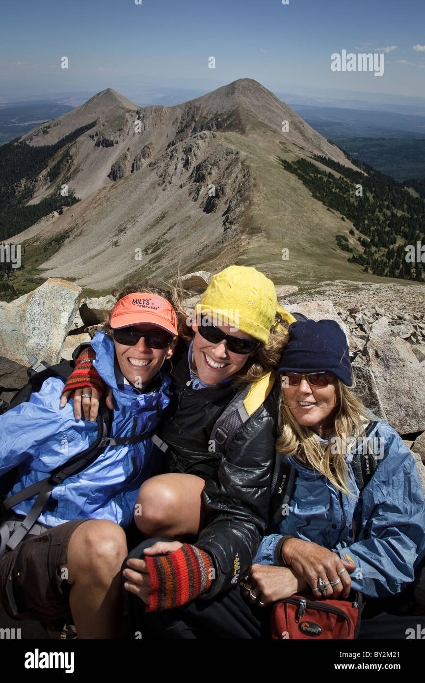 Three women posing for a photo on top of a mountain in the La Sal ...